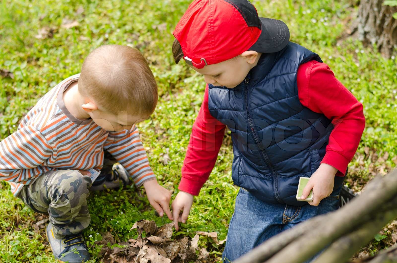Two young boys playing with matches | Stock image | Colourbox