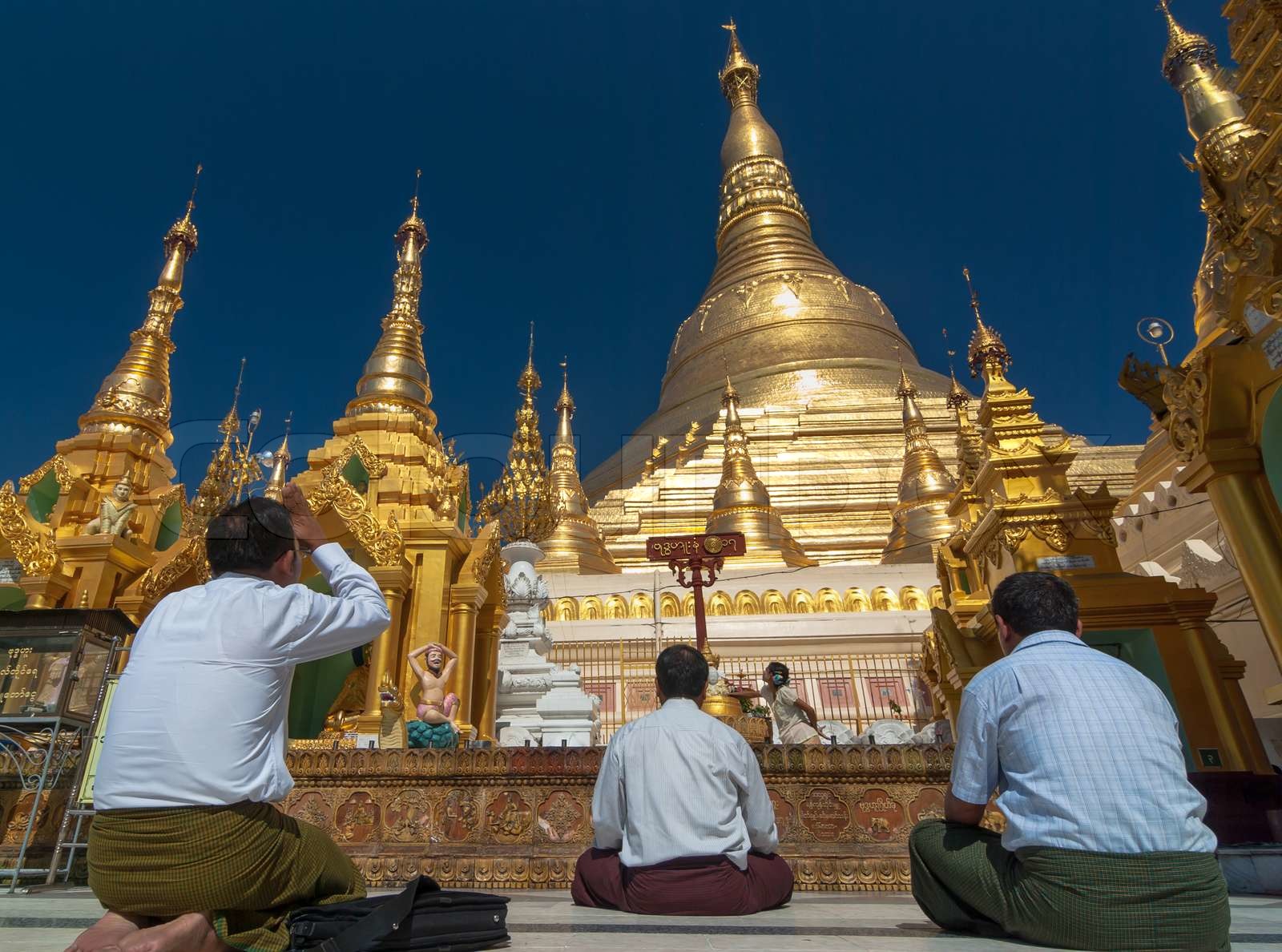 YANGON, MYANMAR - DEC 30: Undefined Buddhist pray at the Shwedagon ...