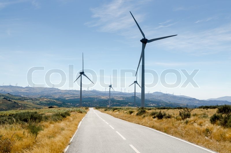 Asphalt road through a wind turbines ... | Stock image | Colourbox