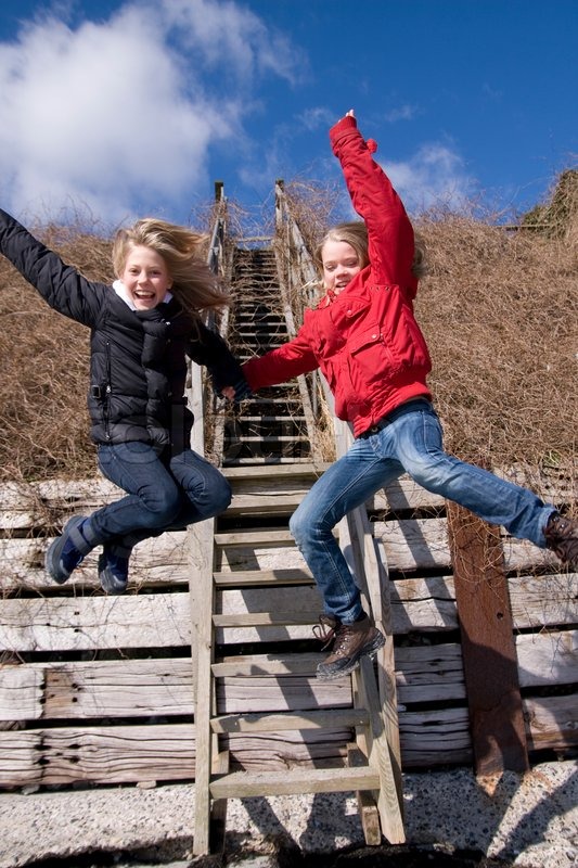 Two teenage girls jumping for joy | Stock image | Colourbox