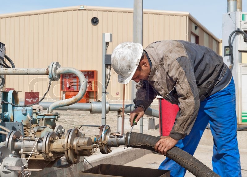 The worker prepares the drain device ... | Stock image | Colourbox