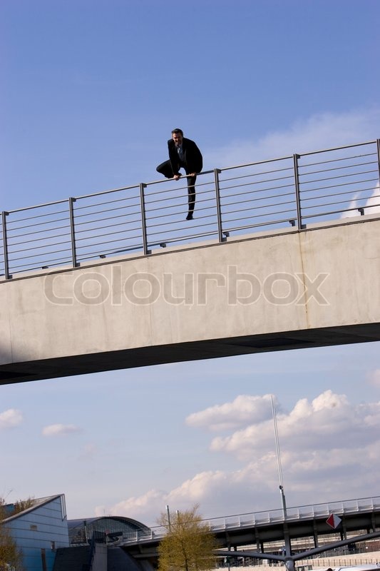 A businessman about to jump a bridge | Stock image | Colourbox