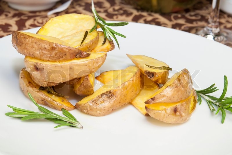 Baked potatoes on the table in a ... | Stock image | Colourbox