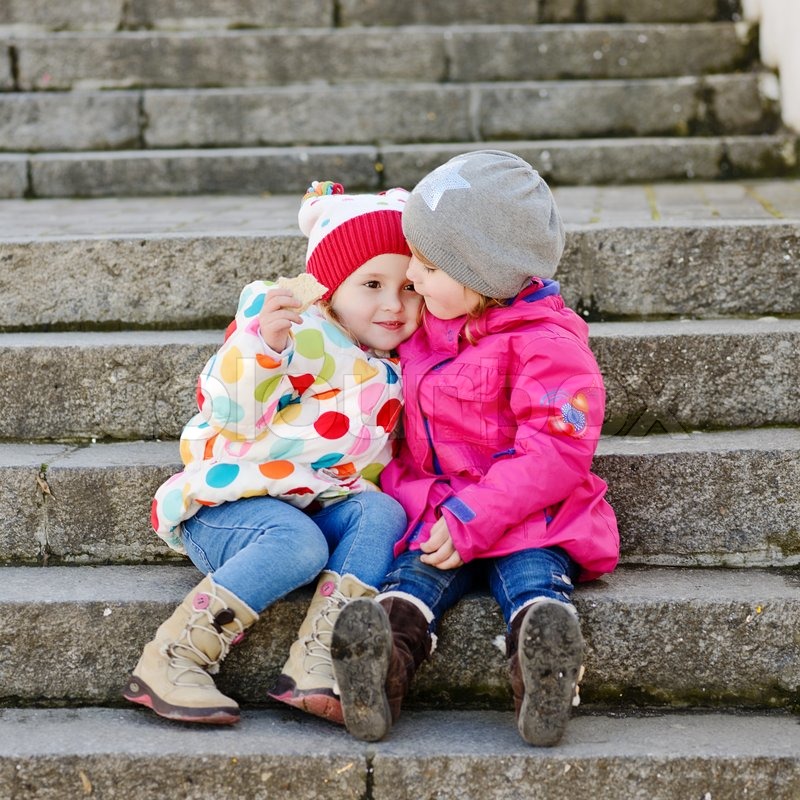 Two toddler friends sitting on the stairs | Stock Photo | Colourbox