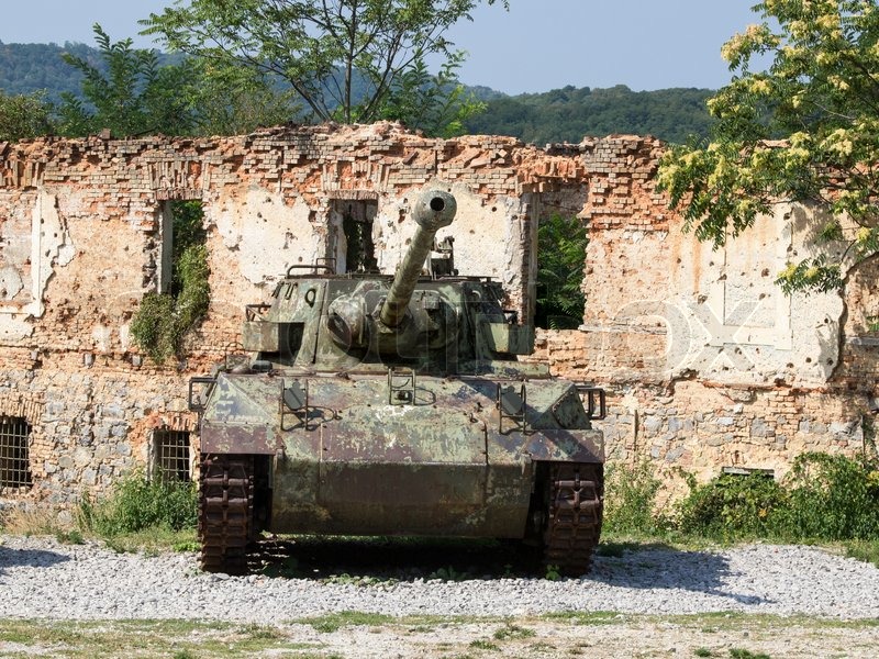 Old army tank infront of burned house | Stock image | Colourbox