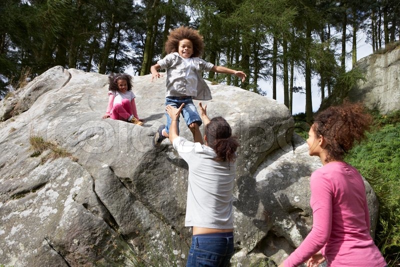 Father Helping Children To Jump Off ... | Stock image | Colourbox