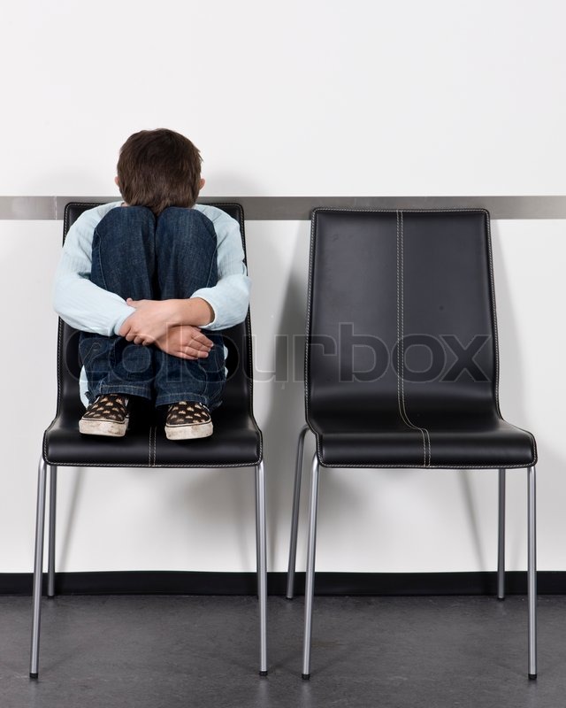 A depressed boy sitting on a chair | Stock image | Colourbox