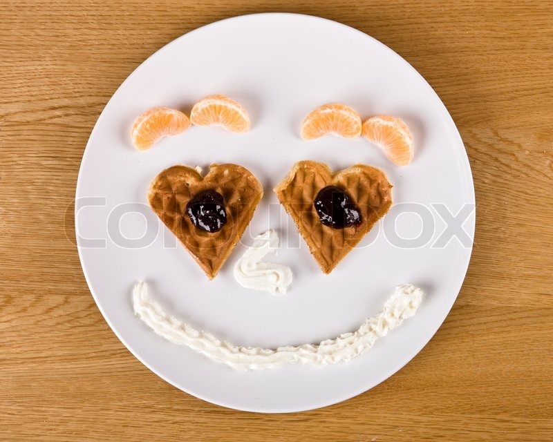 Happy face using waffles and clementine ... | Stock image | Colourbox