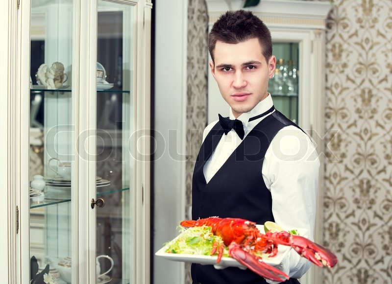 Waiter with a tray of food in the ... | Stock image | Colourbox