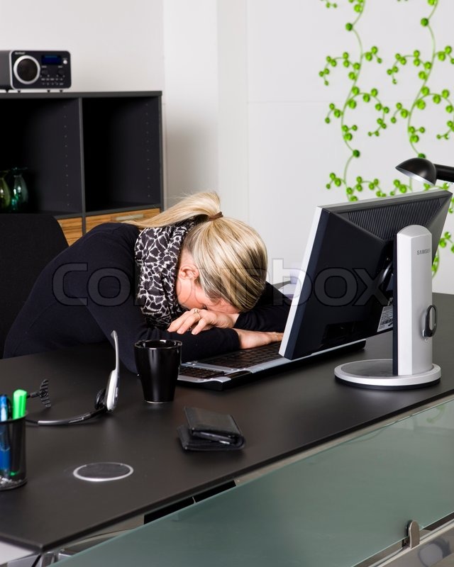 Woman sleeping at her desk | Stock image | Colourbox