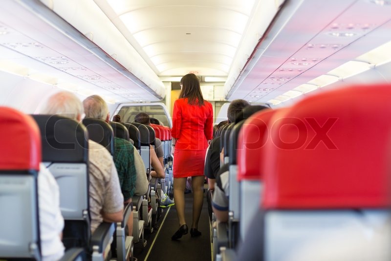 Interior of airplane with passengers on ... | Stock image | Colourbox