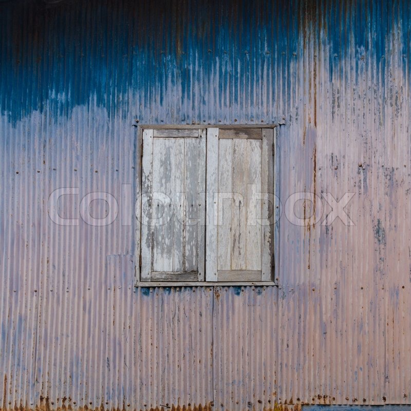 Old rusty house with closed wooden ... | Stock image | Colourbox