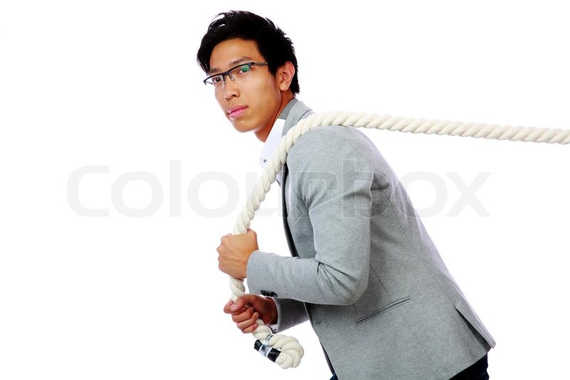 Portrait of a man pulling rope over ... | Stock image | Colourbox
