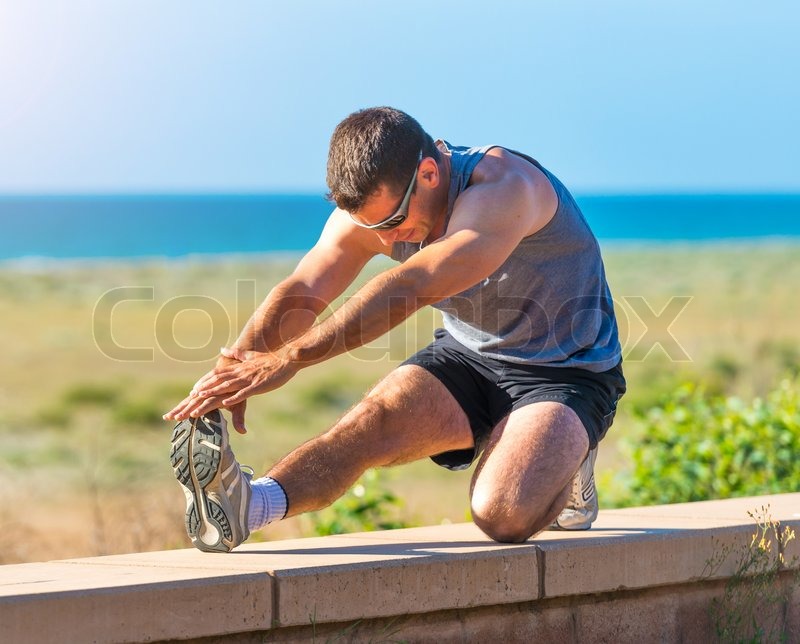 Handsome athlete warming up before ... | Stock image | Colourbox