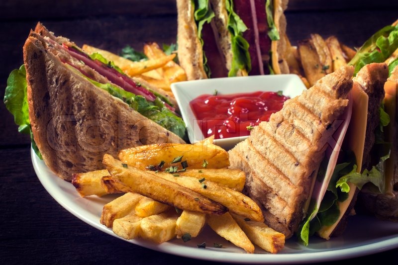 Club sandwiches and french fries in the ... | Stock image | Colourbox