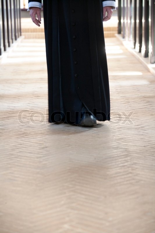 Priest walking inside a church | Stock image | Colourbox