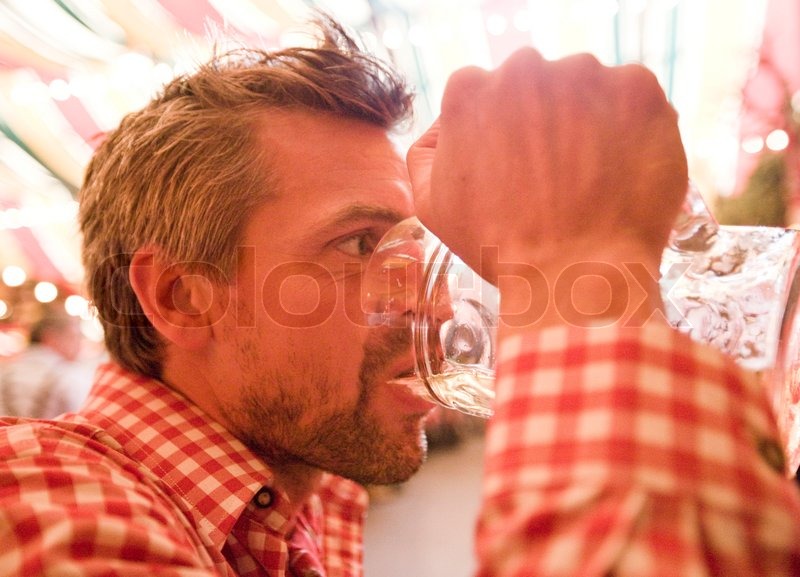 A man drinking a mug of german beer | Stock Photo | Colourbox