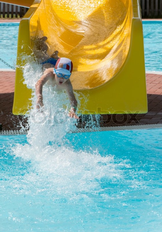 Children slide down a water slide. ... | Stock image | Colourbox