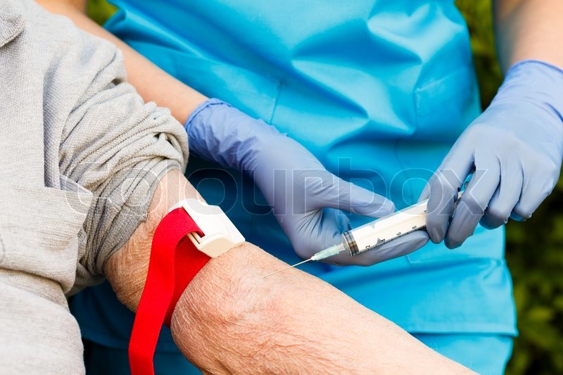 Doctor making venipuncture for her old ... | Stock image | Colourbox