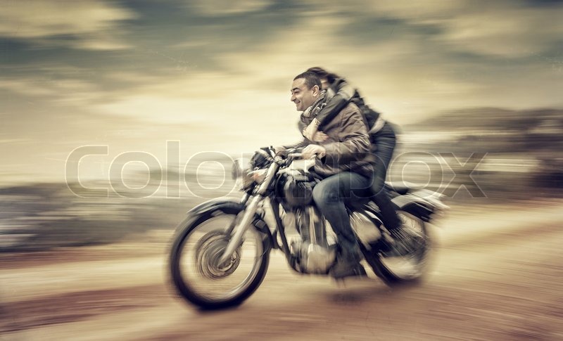 Two happy people riding on motorcycle, ... | Stock Photo | Colourbox