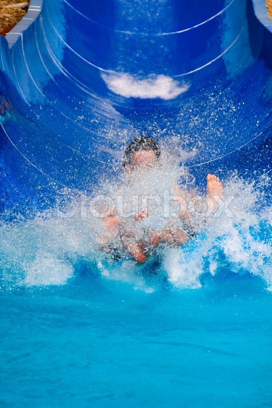 Two men having fun, people water slide ... | Stock image | Colourbox
