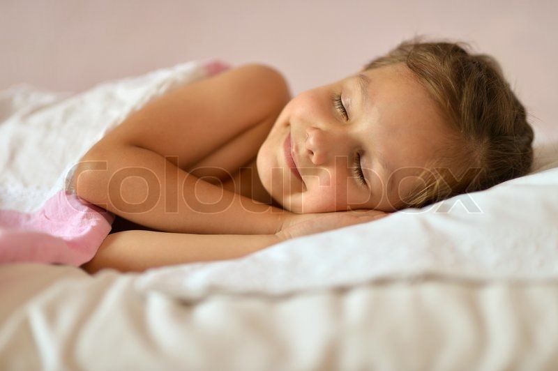 Cute girl sleeping in her bed at home | Stock image | Colourbox