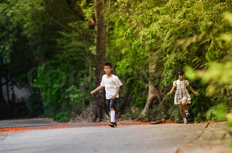 Asian children running in to the ... | Stock image | Colourbox