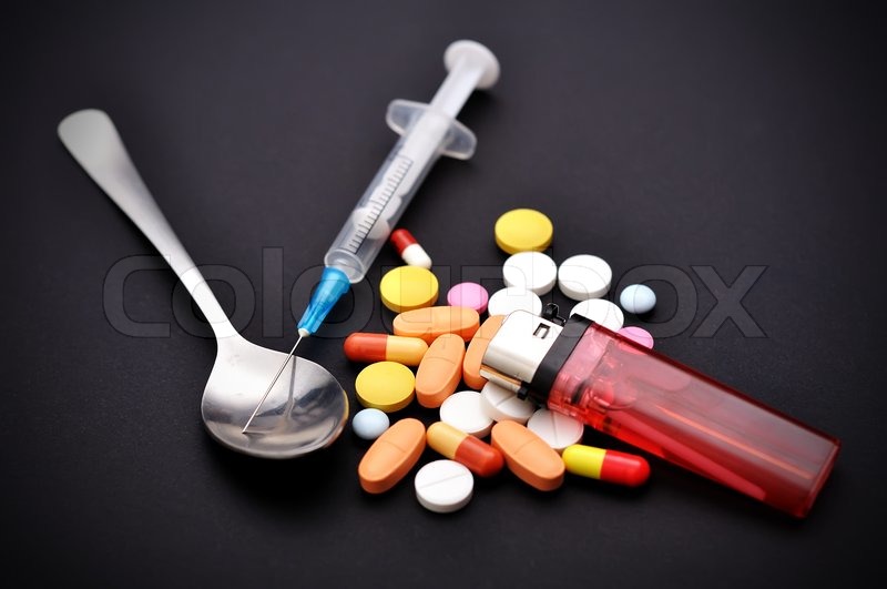 Narcotic pills and syringe on black ... | Stock image | Colourbox