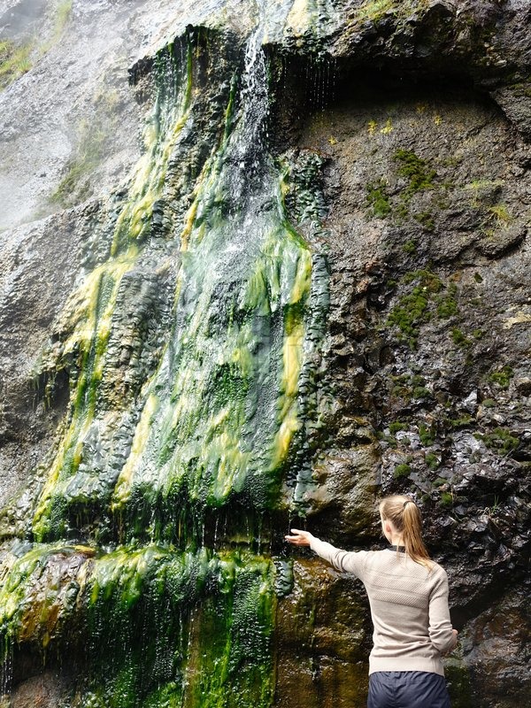 Water streaming down the green rocks in ... | Stock image | Colourbox