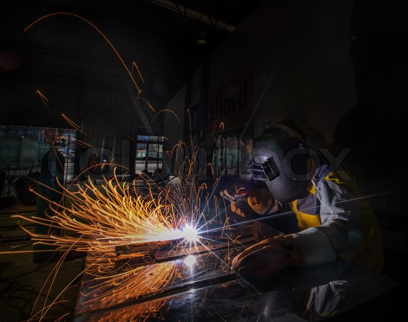 Worker welding in production line | Stock image | Colourbox