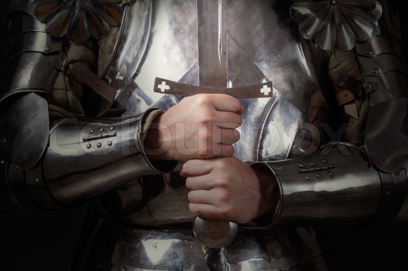 Knight wearing armor and holding ... | Stock image | Colourbox