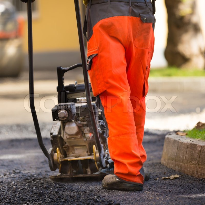 Construction workers during asphalting ... | Stock image | Colourbox