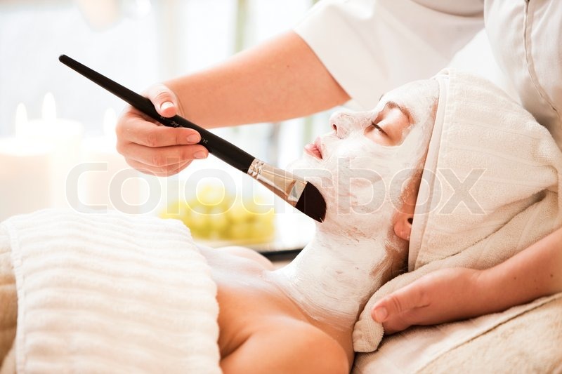 A female caucasian in a wellness spa getting facial treatment | Stock ...