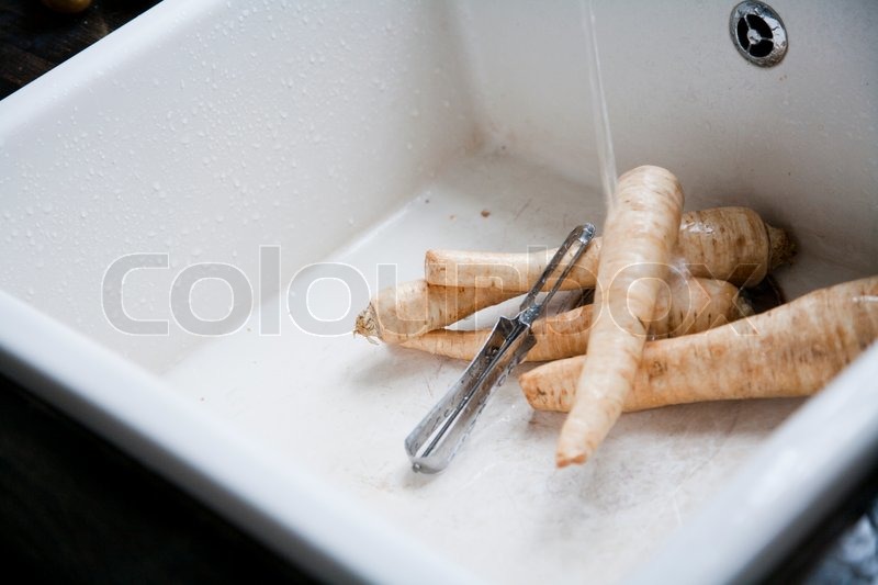 Washing parsley roots | Stock Photo | Colourbox