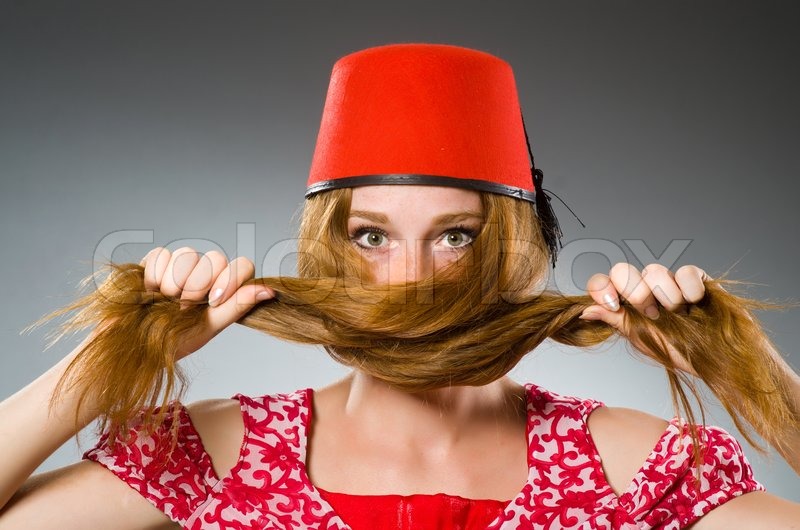 Woman wearing red fez hat | Stock image | Colourbox
