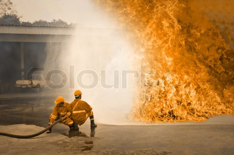Firemen in action fighting fire during ... | Stock image | Colourbox