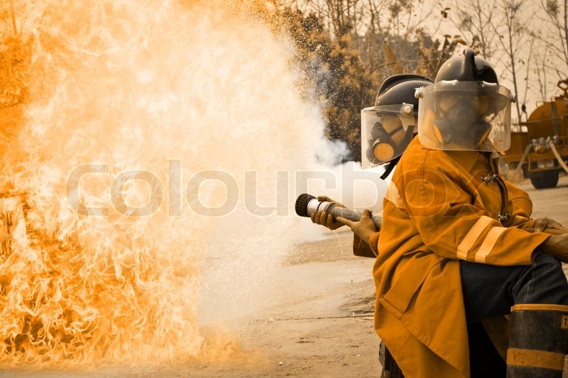 Firemen in action fighting fire during ... | Stock image | Colourbox