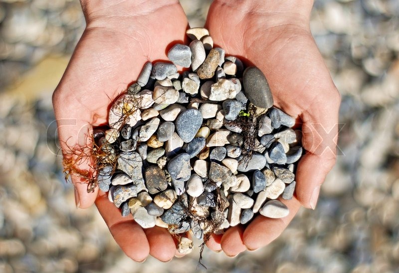 Handful of stones in hands | Stock image | Colourbox