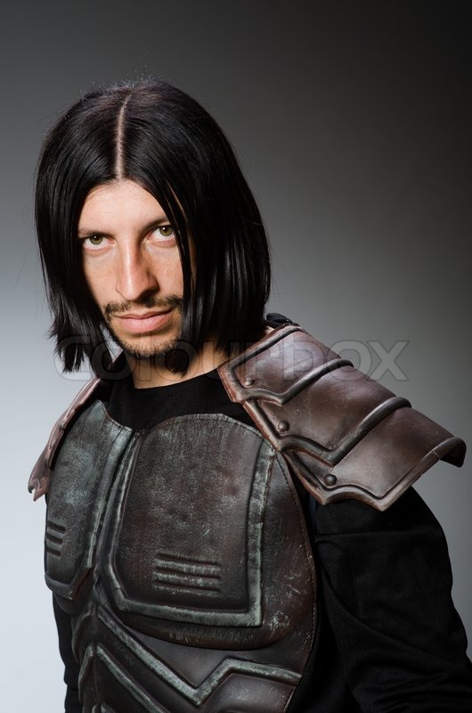 Angry warrior against dark background | Stock image | Colourbox