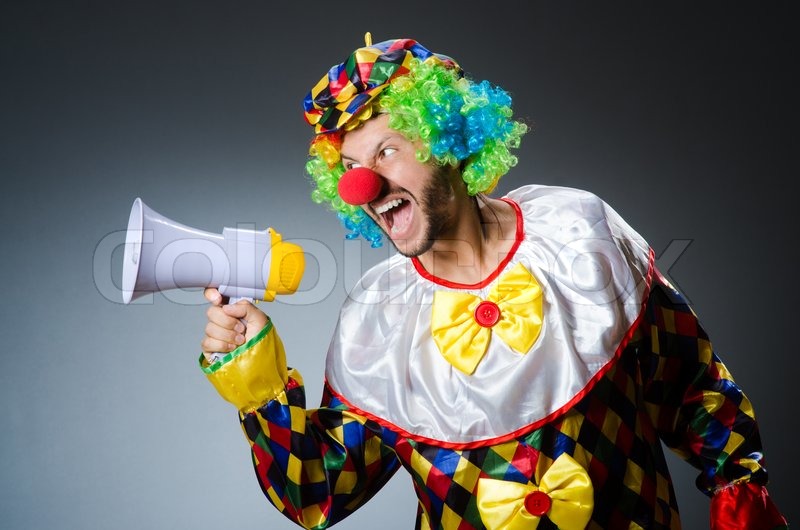 Clown with loudspealer against curtain | Stock image | Colourbox