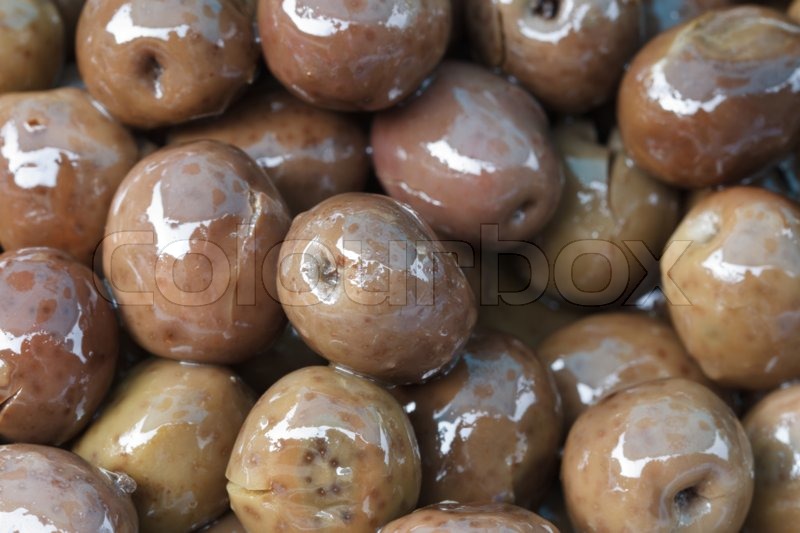 Brownish olives in oil close up. ... | Stock image | Colourbox