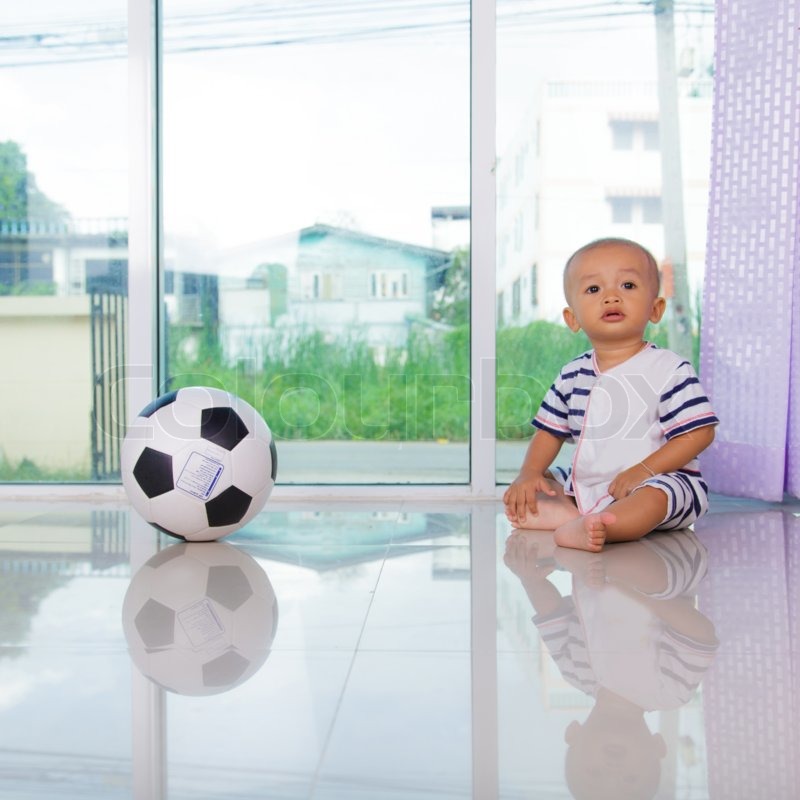 Portrait of a baby with football in the ... | Stock image | Colourbox