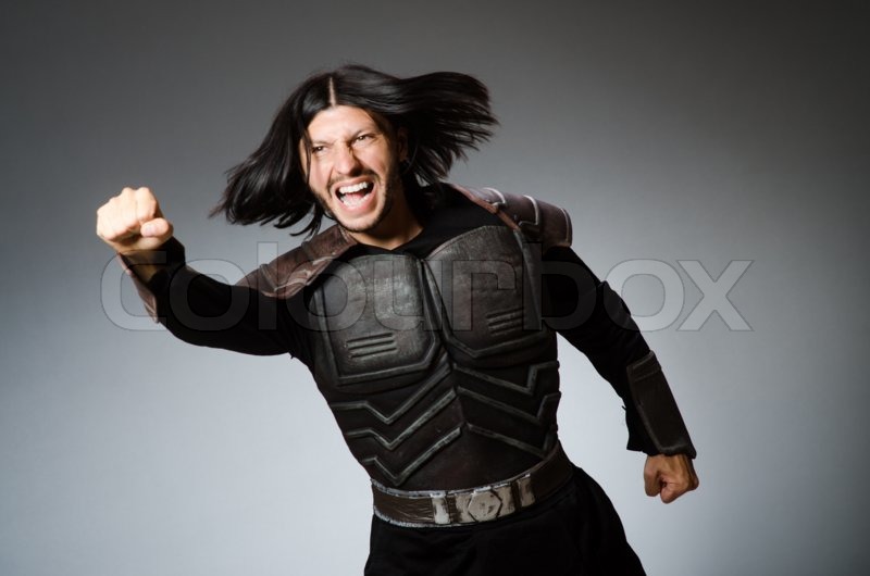 Angry warrior against dark background | Stock image | Colourbox