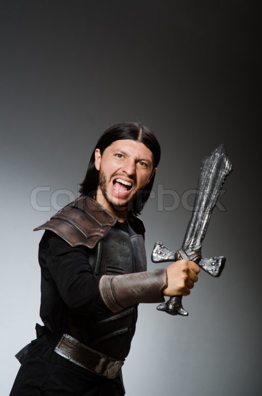 Angry knight with sword against dark ... | Stock image | Colourbox