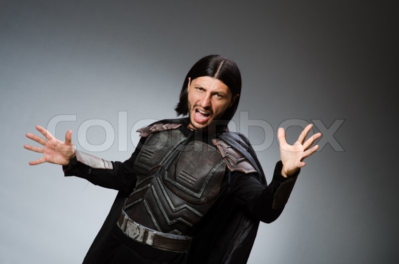 Angry warrior against dark background | Stock image | Colourbox