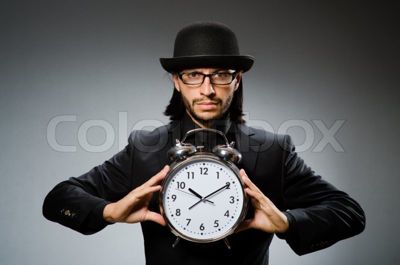 Man with clock wearing vintage hat | Stock image | Colourbox