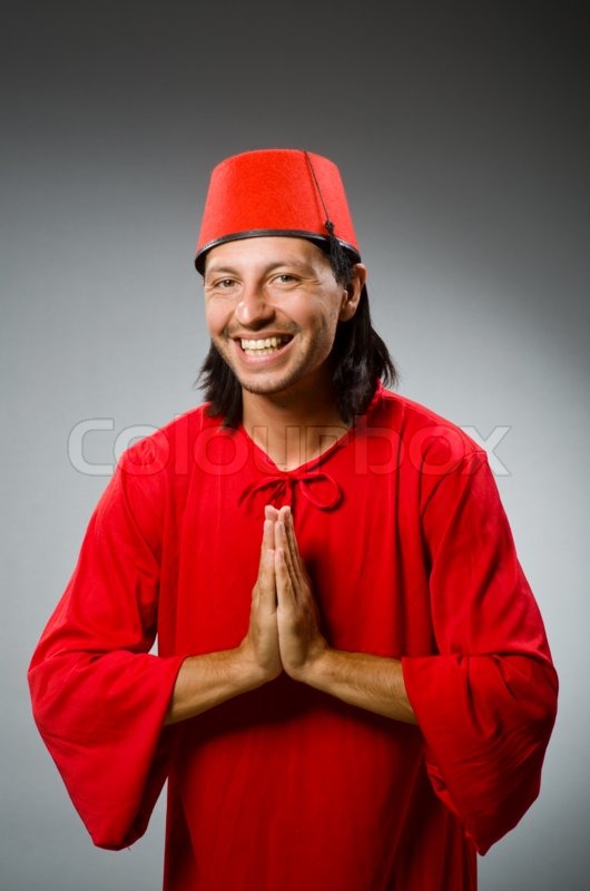 Man in red dress wearing fez hat | Stock image | Colourbox