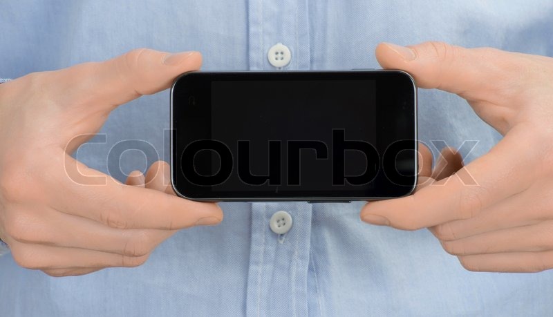 Hands holding mobile isolated on white | Stock image | Colourbox
