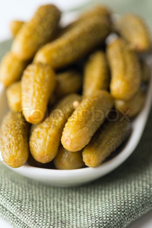 Dill pickles in bowl in soft focus. ... | Stock image | Colourbox
