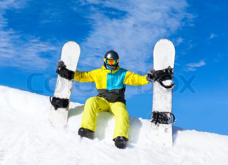 Snowboarder sitting on snow mountains ... | Stock Photo | Colourbox